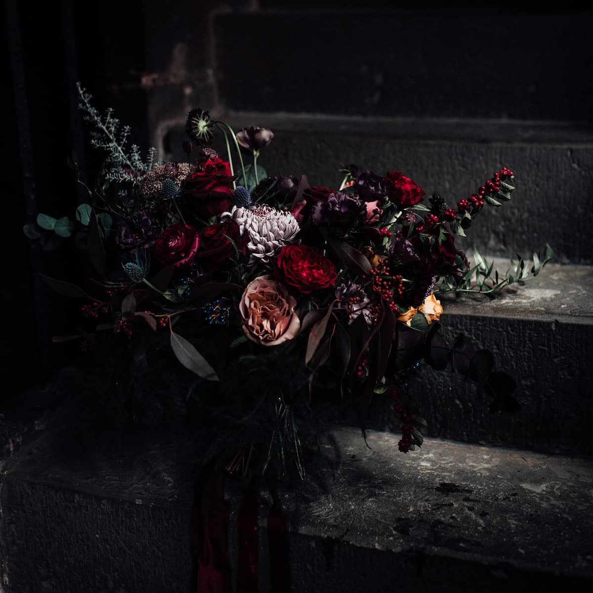 Dark, moody gothic wedding bouquet ideas, including flower guide